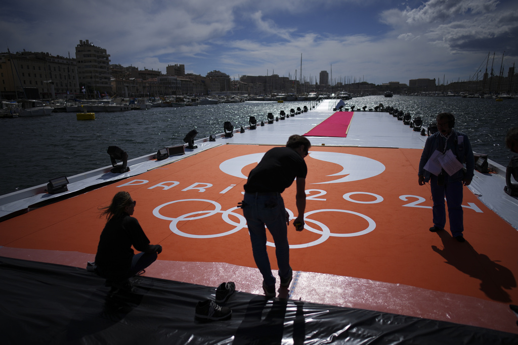 A ship carrying the Olympic torch arrives in Marseille amid fanfare and ...